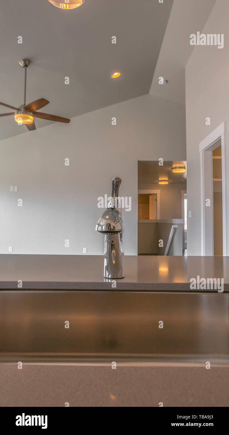 frame Vertical Glossy sink and faucet on the brown countertop inside a ...