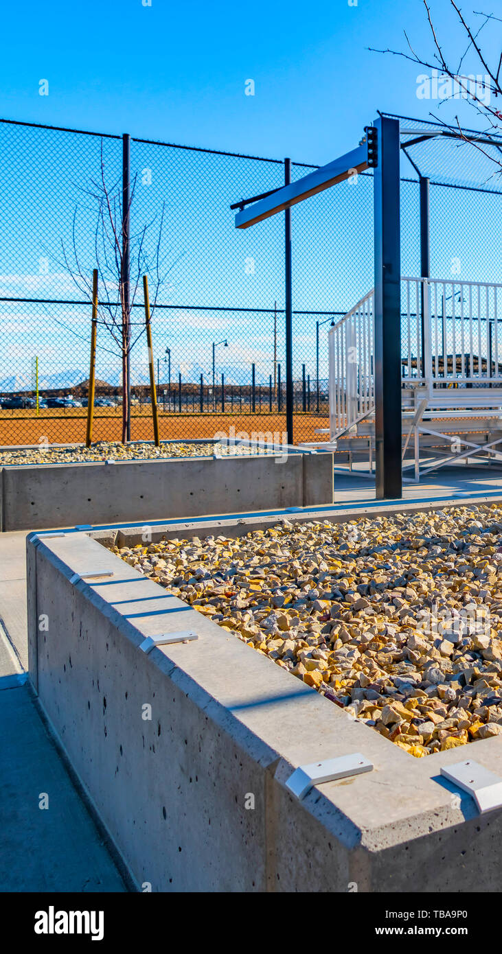 frame Vertical Raised concrete square beds with rocks and tree saplings ...