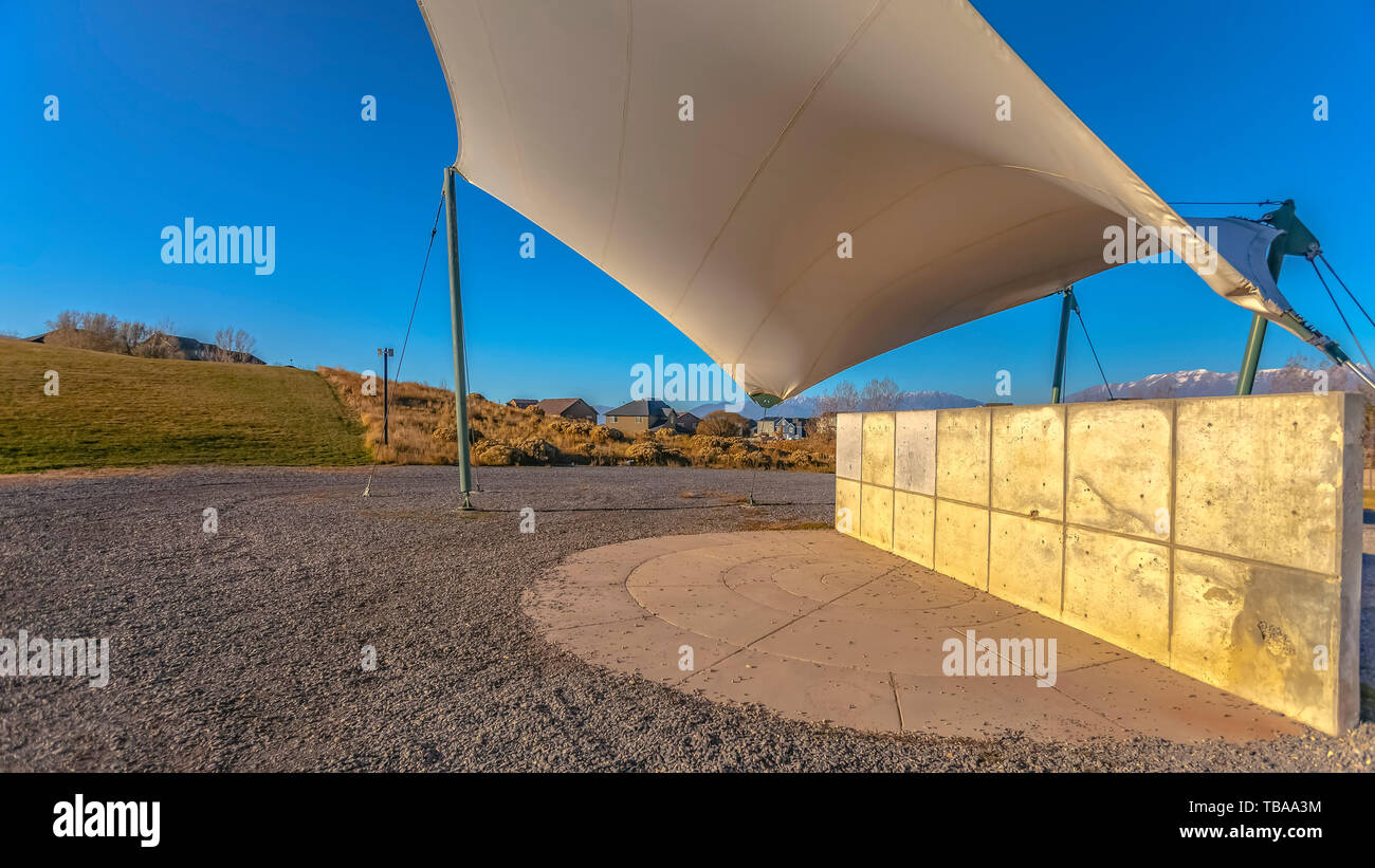 Panorama frame Concrete rectangular structure on a rocky ground under a ...
