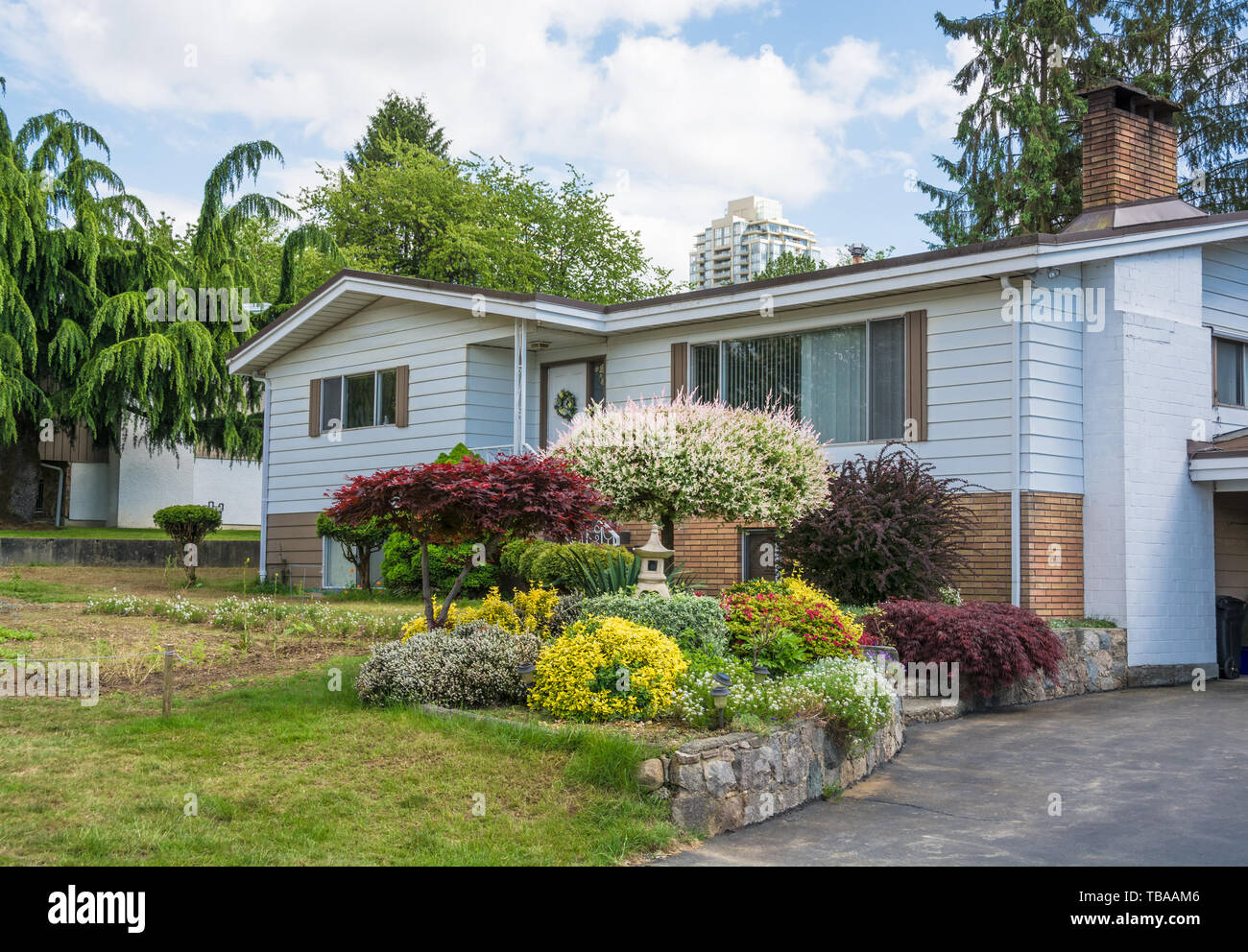 Family house with landscaped front yard on cloudy sky background Stock ...