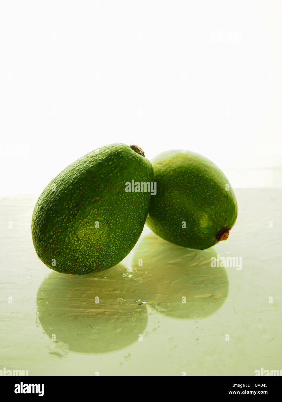 Two avocados isolated on white background Stock Photo - Alamy