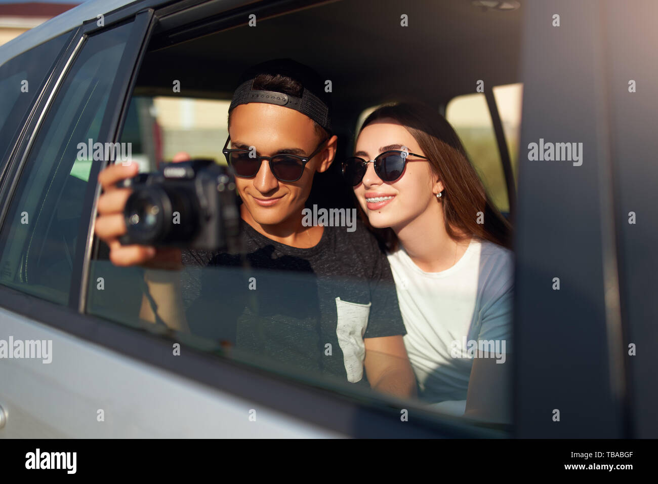 Blogger in glasses filming his travel vlog on professional camera on ...