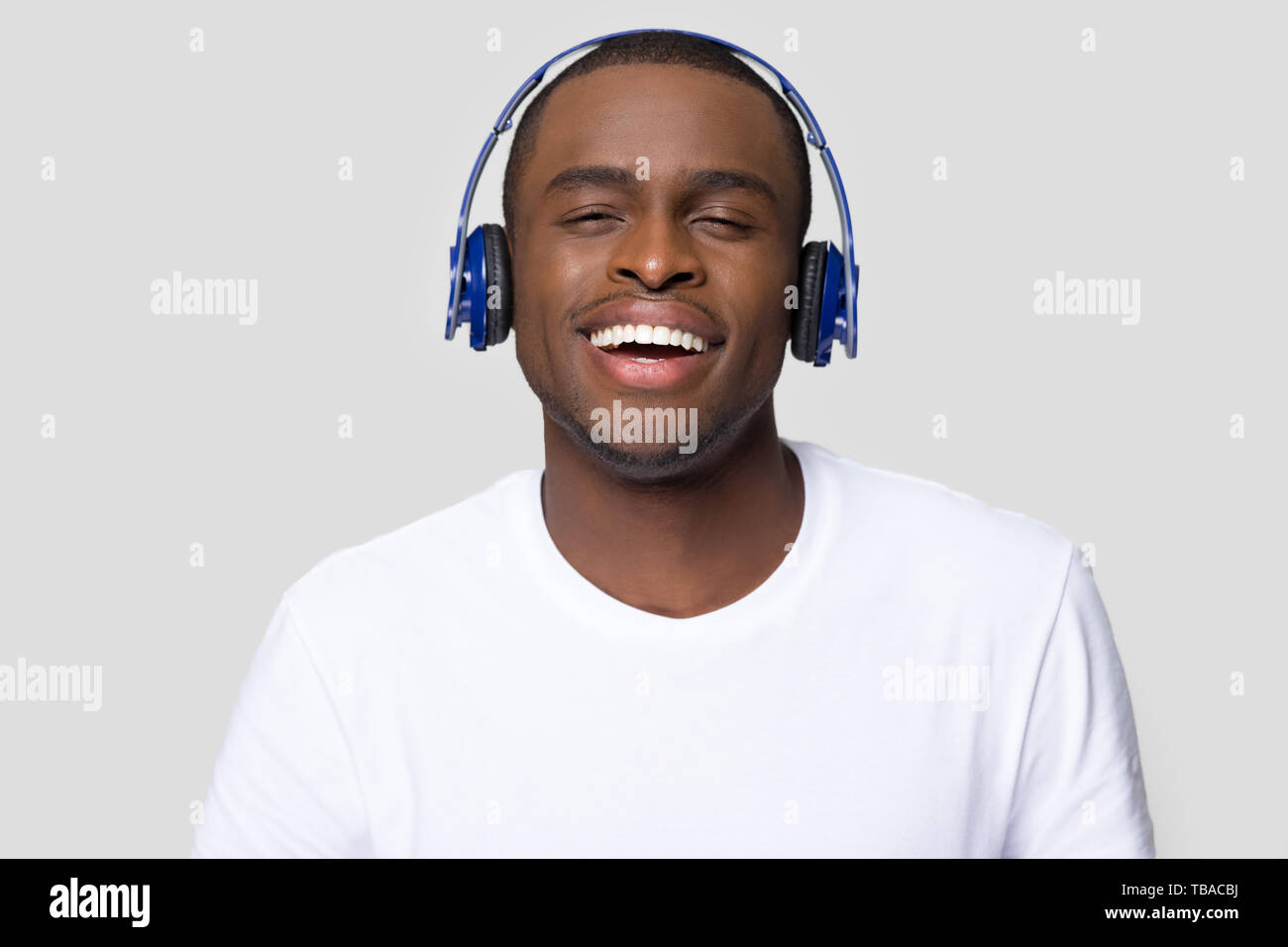 African male laughing enjoy music listening using headphones Stock ...