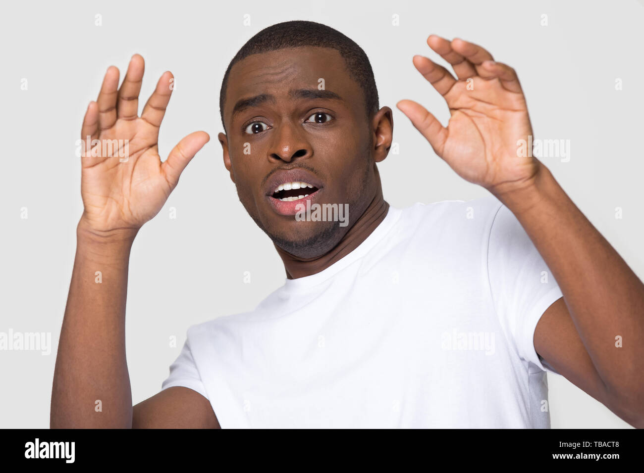 African male looking at camera make big eyes feels scared Stock Photo ...
