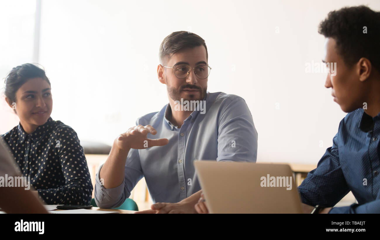 Diverse colleagues talk discussing hi-res stock photography and images ...