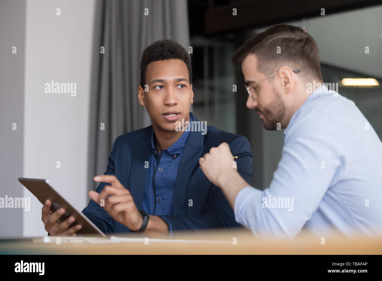 African American employee explain project to colleague at meeting Stock ...