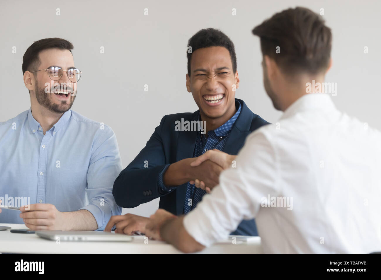 Smiling businessmen handshake getting acquainted at meeting Stock Photo ...