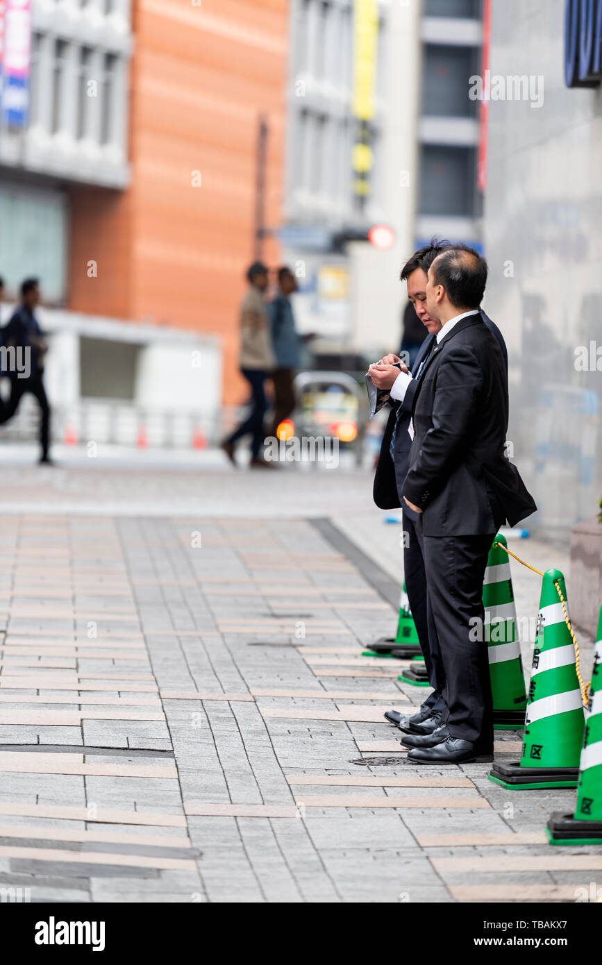 Tokyo, Japan - March 30, 2019: Shinjuku street sidewalk near station ...