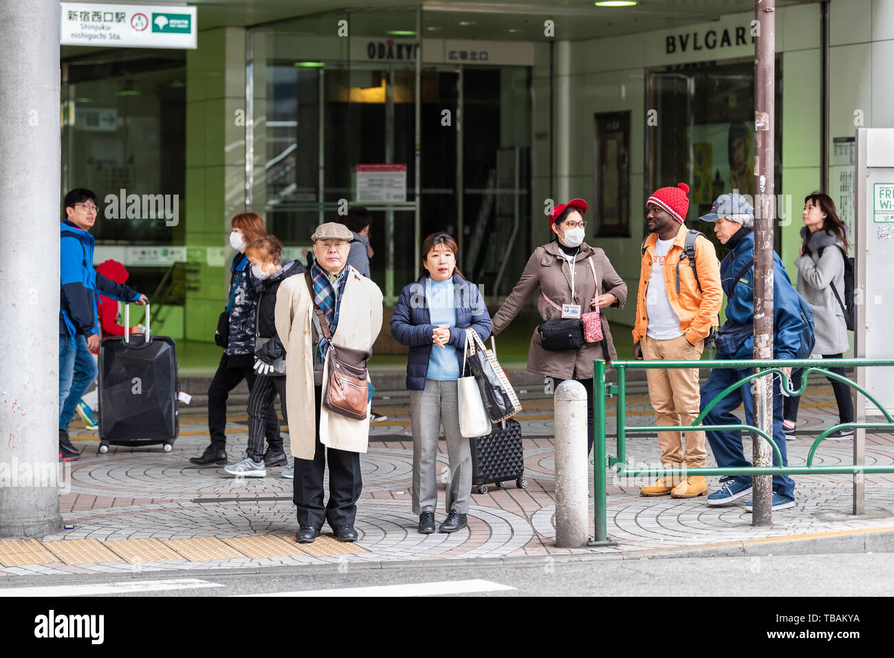 Tokyo, Japan - March 30, 2019: Shinjuku street sidewalk with people ...