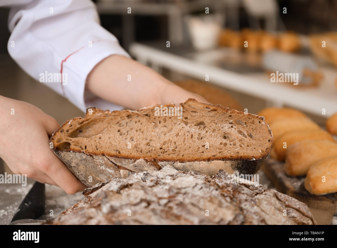 Female chef cut black bread hi-res stock photography and images - Alamy