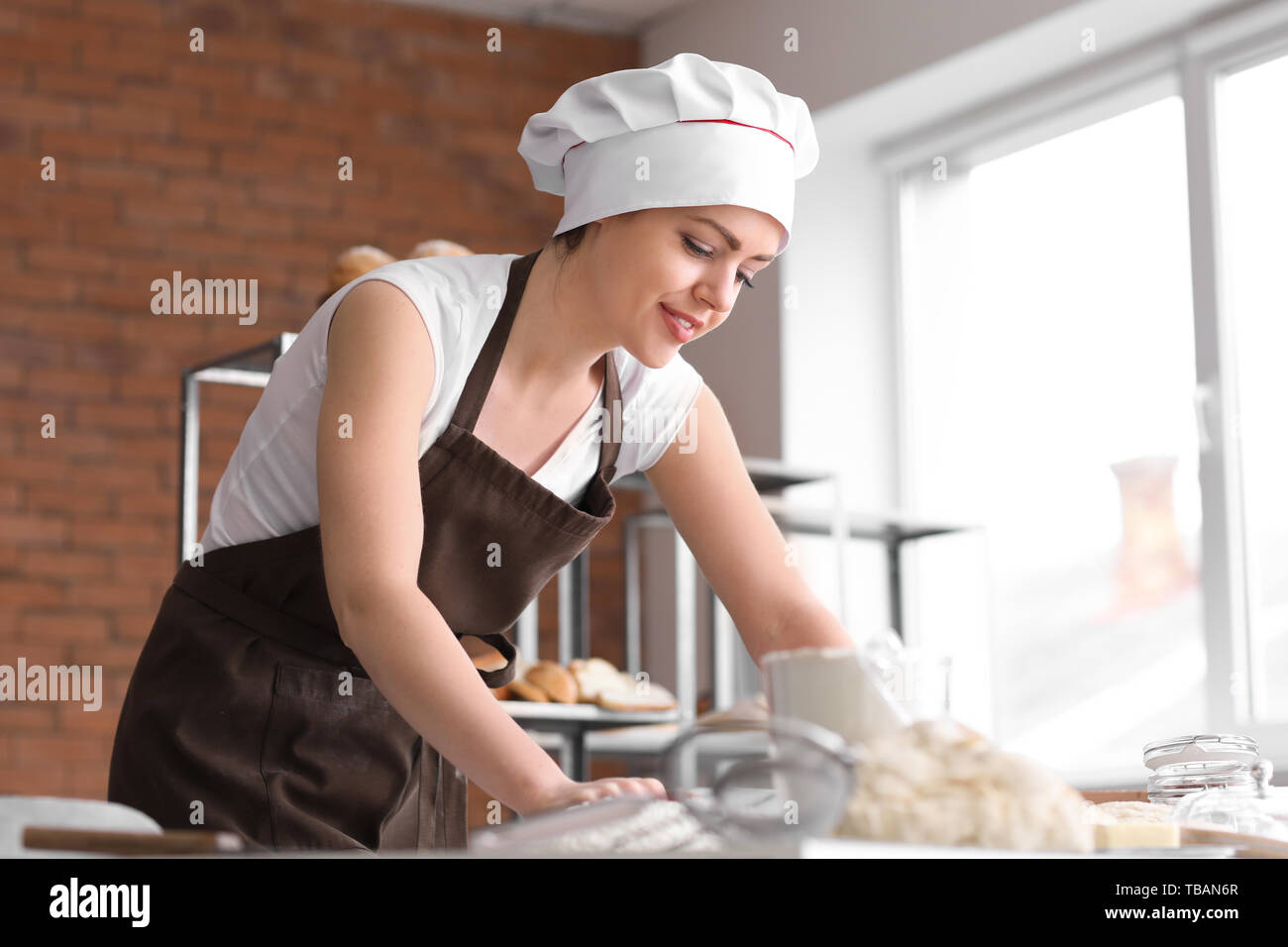 Female baker making dough in kitchen Stock Photo - Alamy