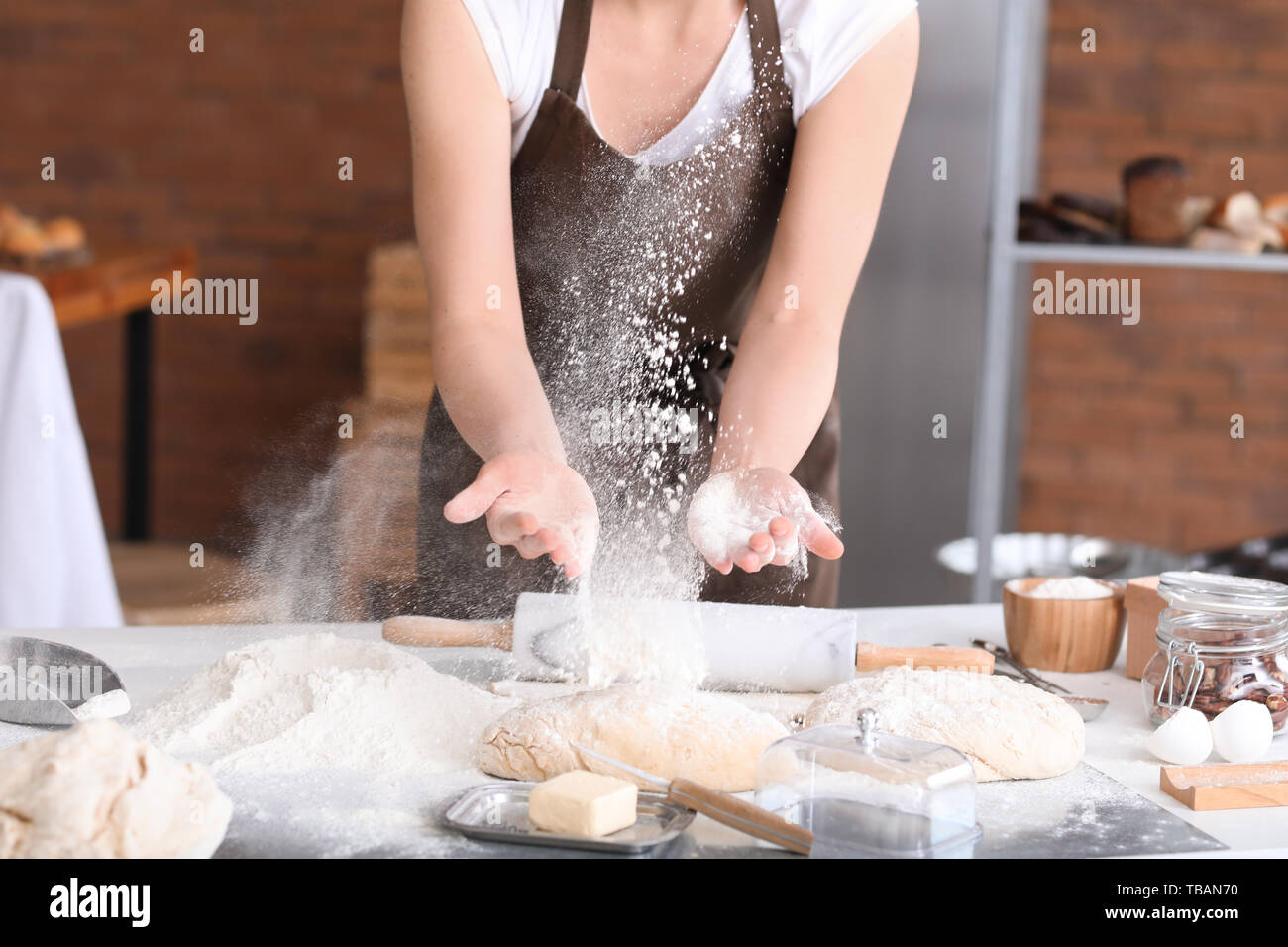 Female baker making dough in kitchen Stock Photo - Alamy