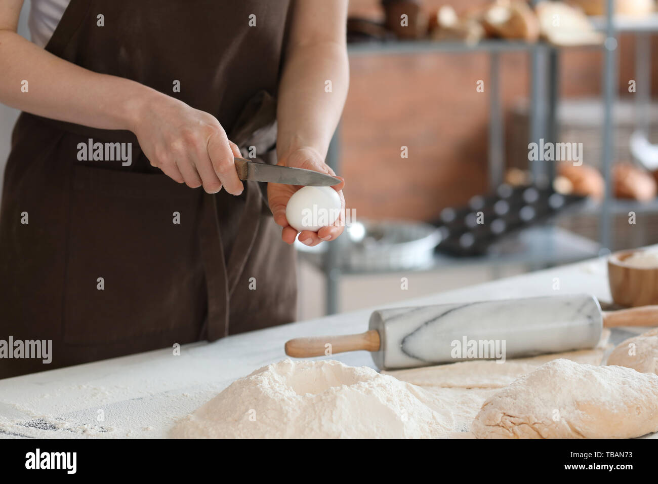 Female baker making dough in kitchen Stock Photo - Alamy