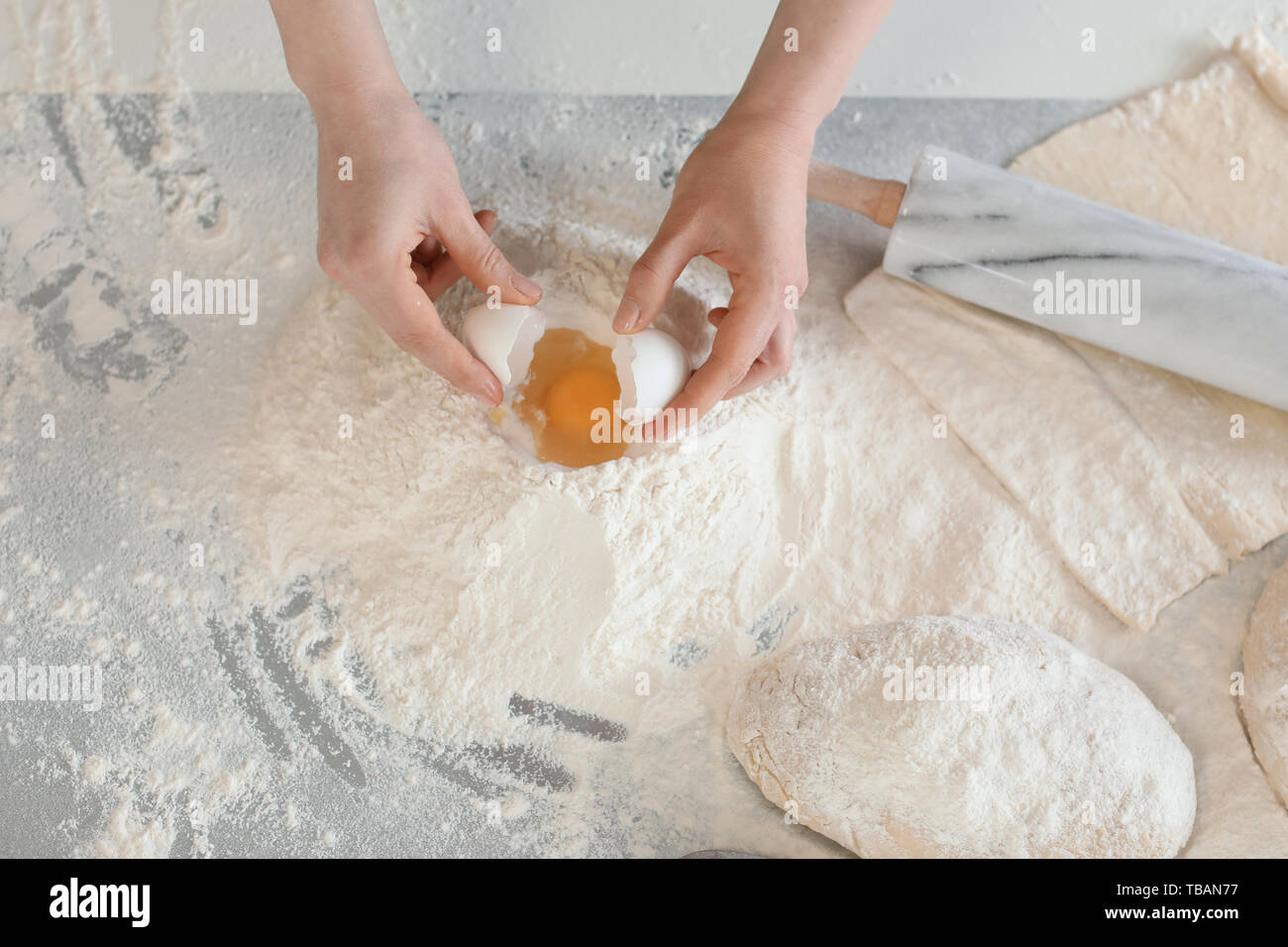 Female baker making dough in kitchen Stock Photo - Alamy