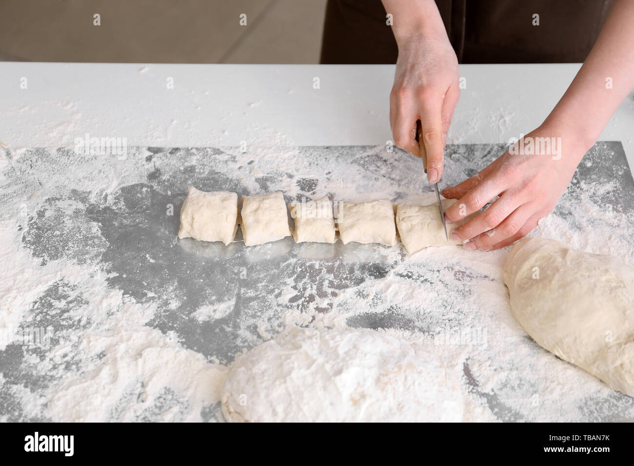 Female baker cooking buns in kitchen Stock Photo - Alamy