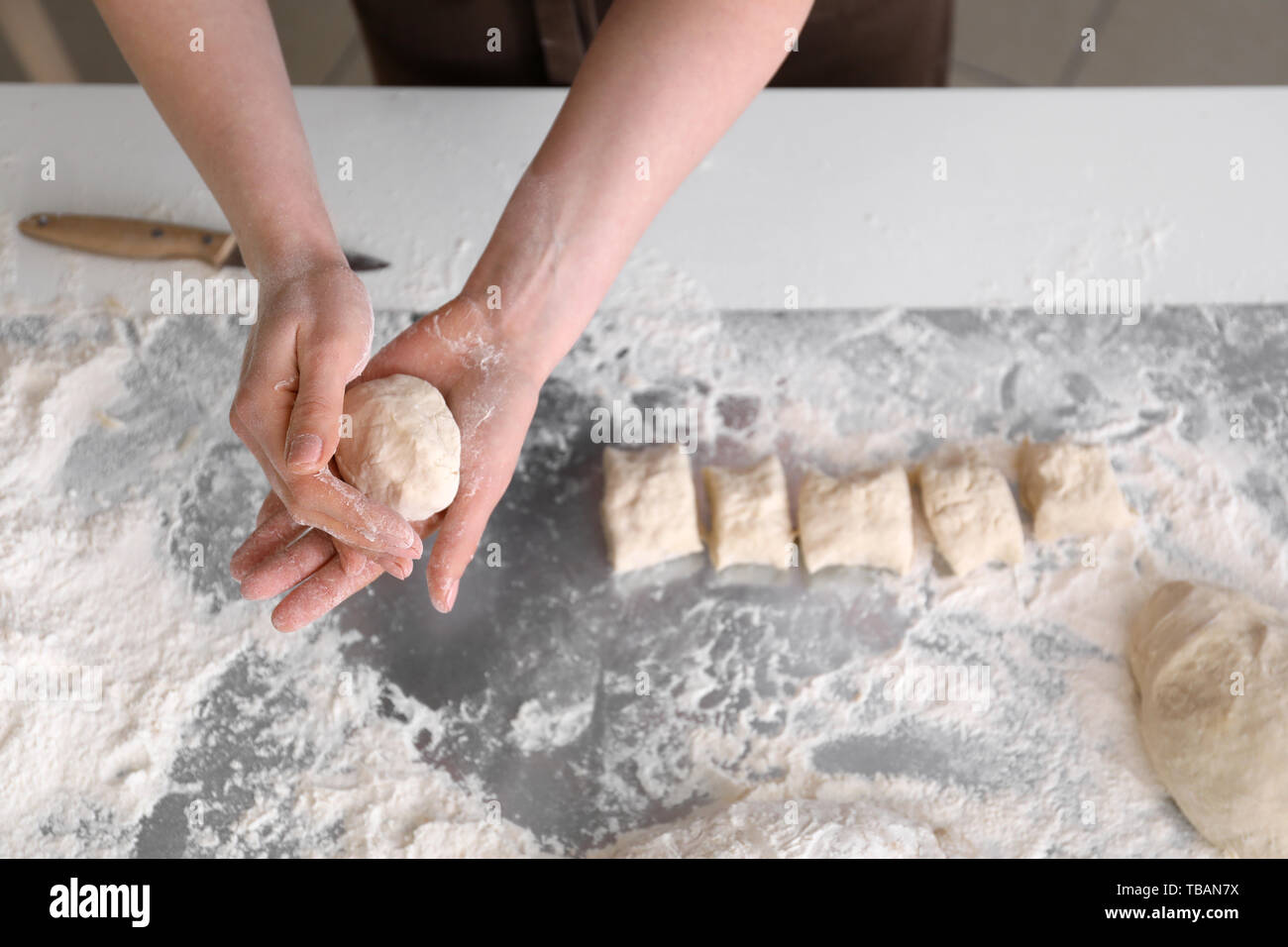 Female baker cooking buns in kitchen Stock Photo - Alamy