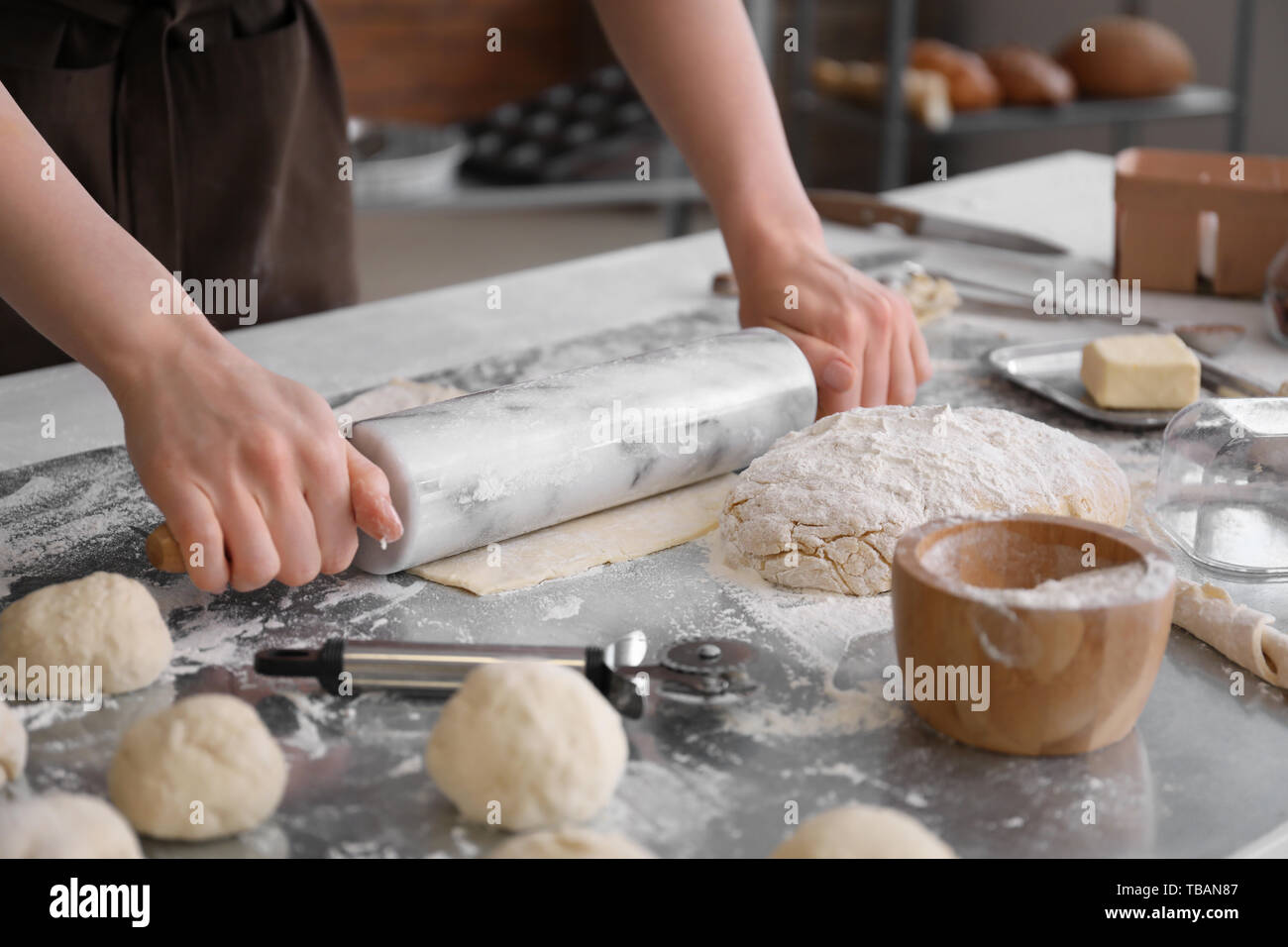 Female baker making dough for buns in kitchen Stock Photo - Alamy