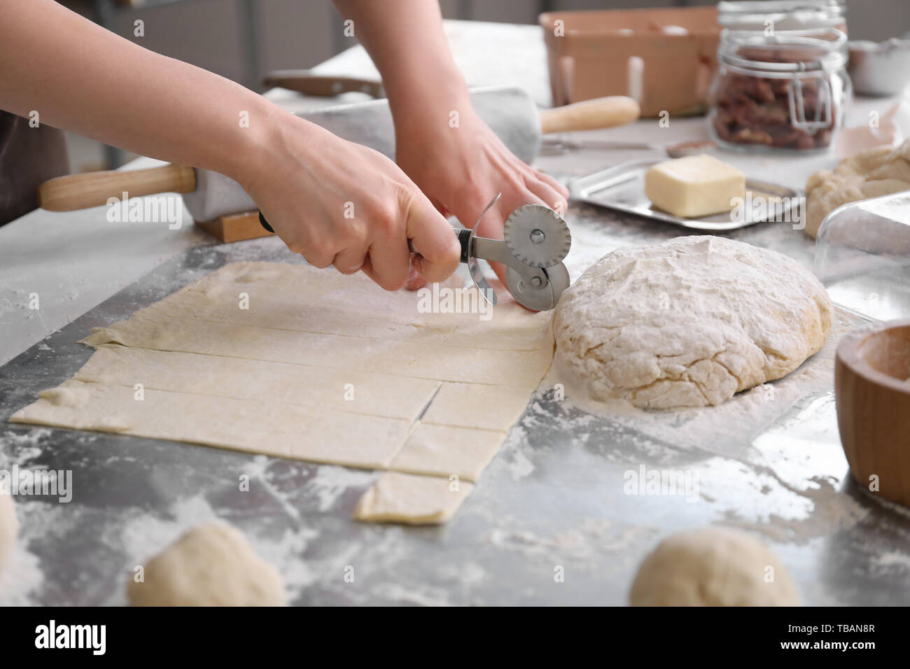 Female baker making cookies in kitchen Stock Photo - Alamy