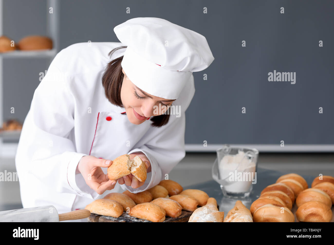 Female chef with freshly baked pastry in kitchen Stock Photo - Alamy