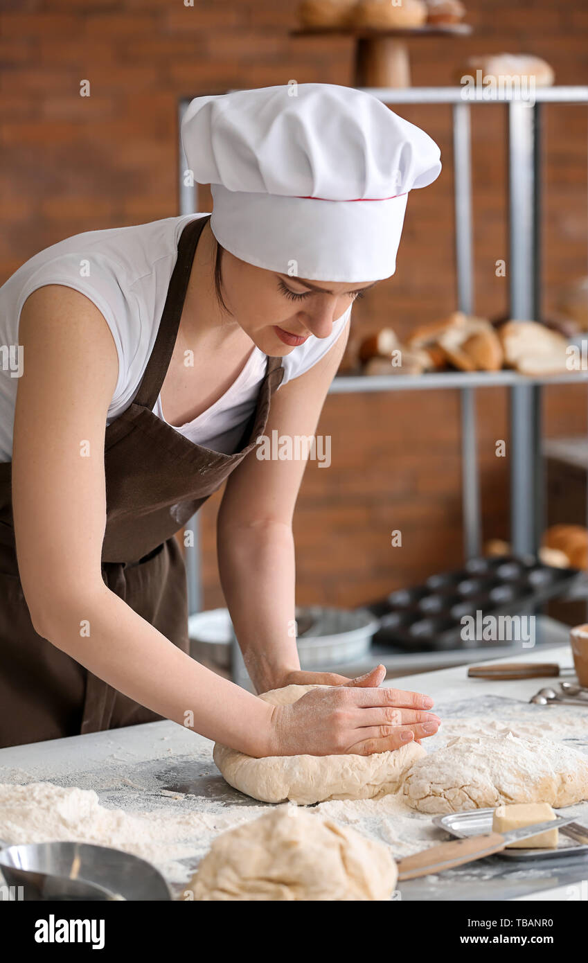 Female baker making dough in kitchen Stock Photo - Alamy