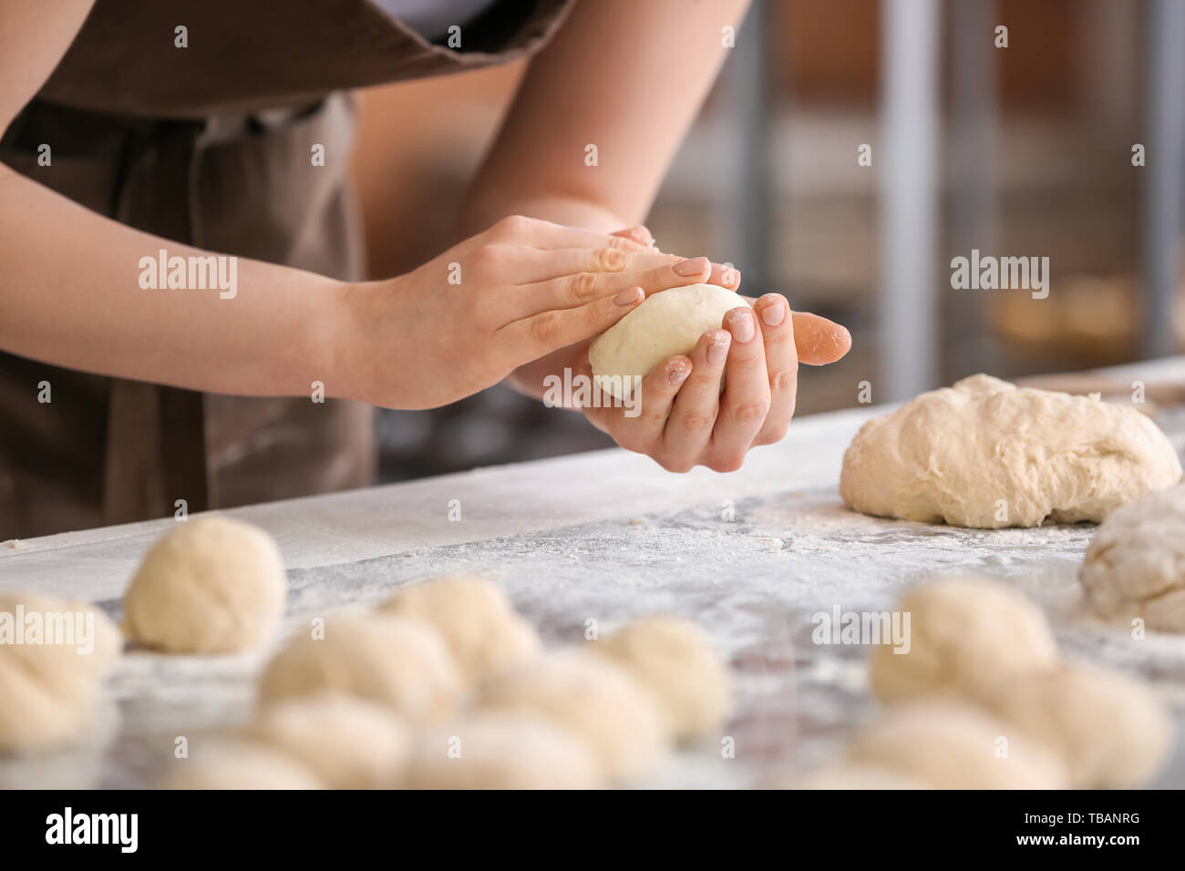 Female baker cooking buns in kitchen Stock Photo - Alamy