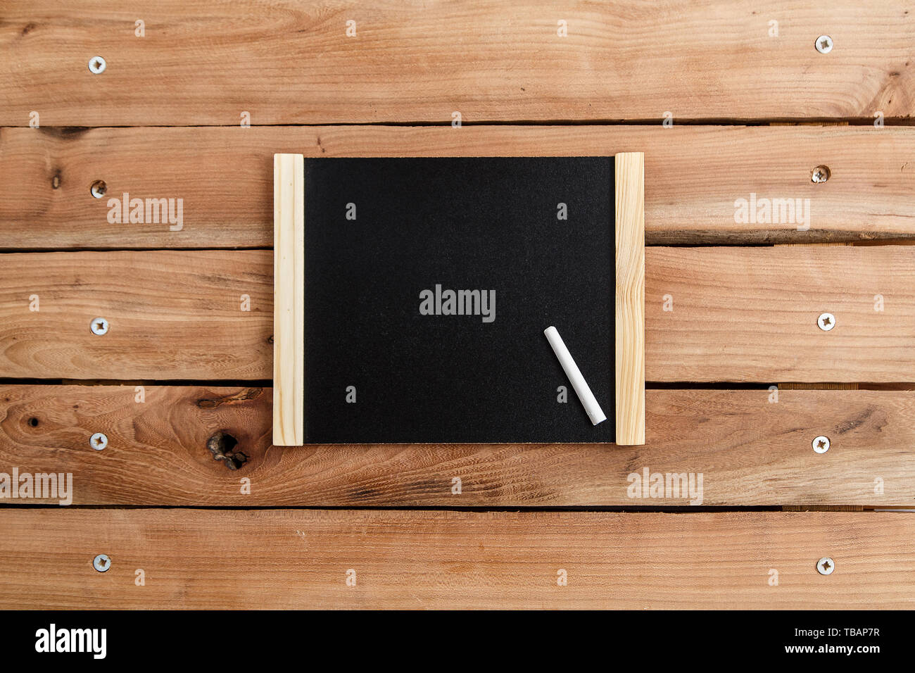 chalkboard with chalk on wooden background Stock Photo - Alamy