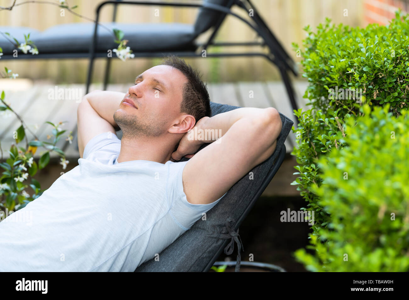 Man sleeping in chair hi-res stock photography and images - Alamy