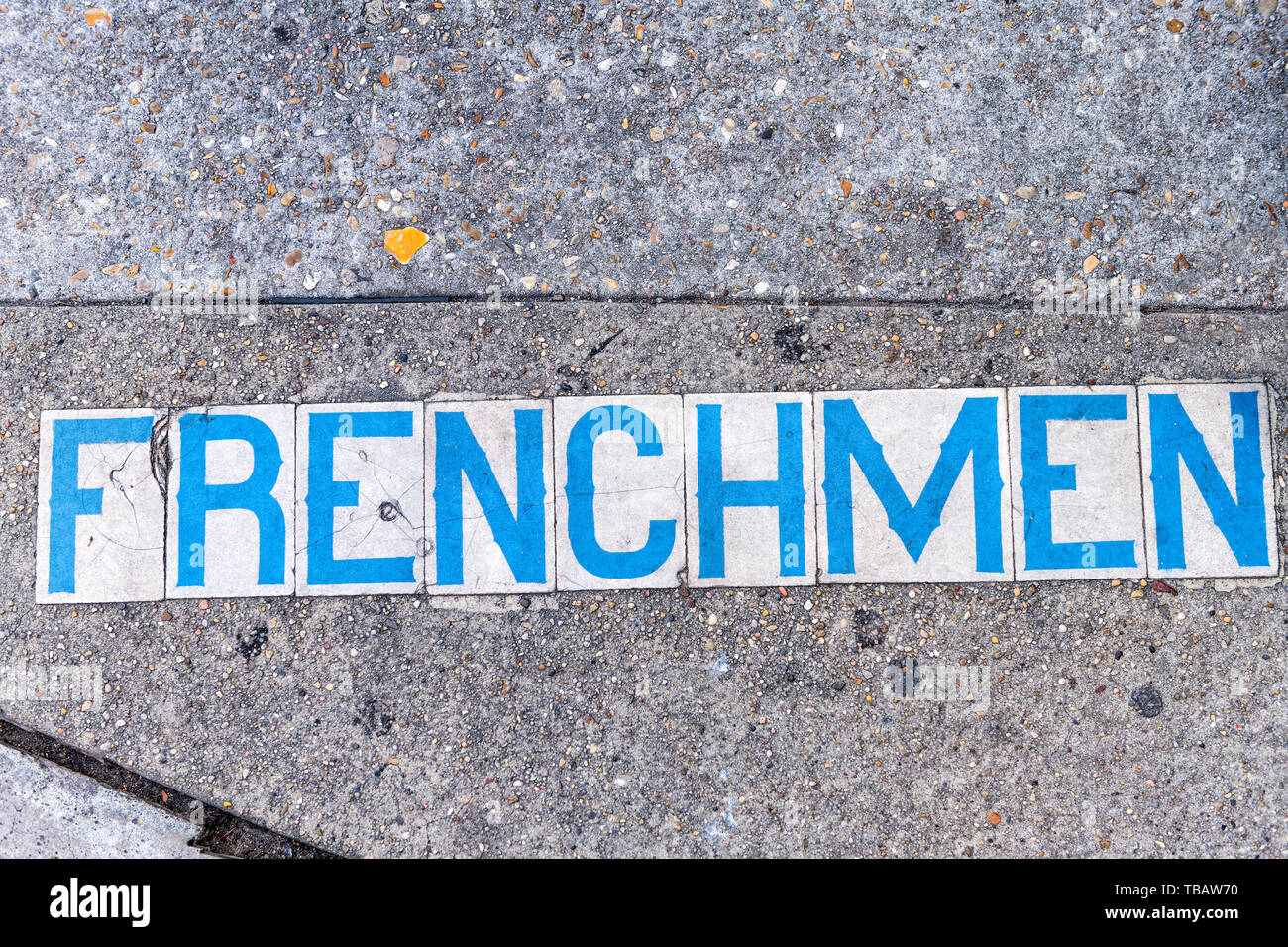 Historic old town Frenchmen street sign on sidewalk pavement in New ...