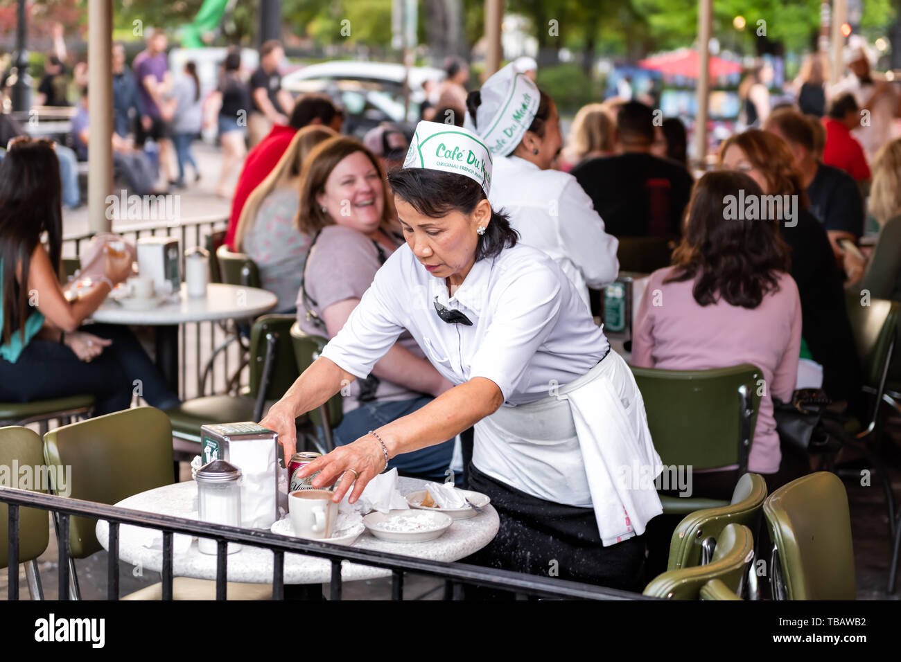 New Orleans, USA - April 23, 2018: Female waitress woman cleaning up ...