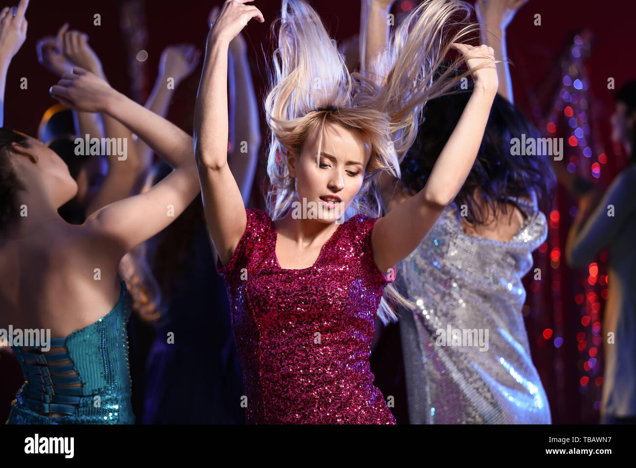 Beautiful young woman dancing in night club Stock Photo - Alamy