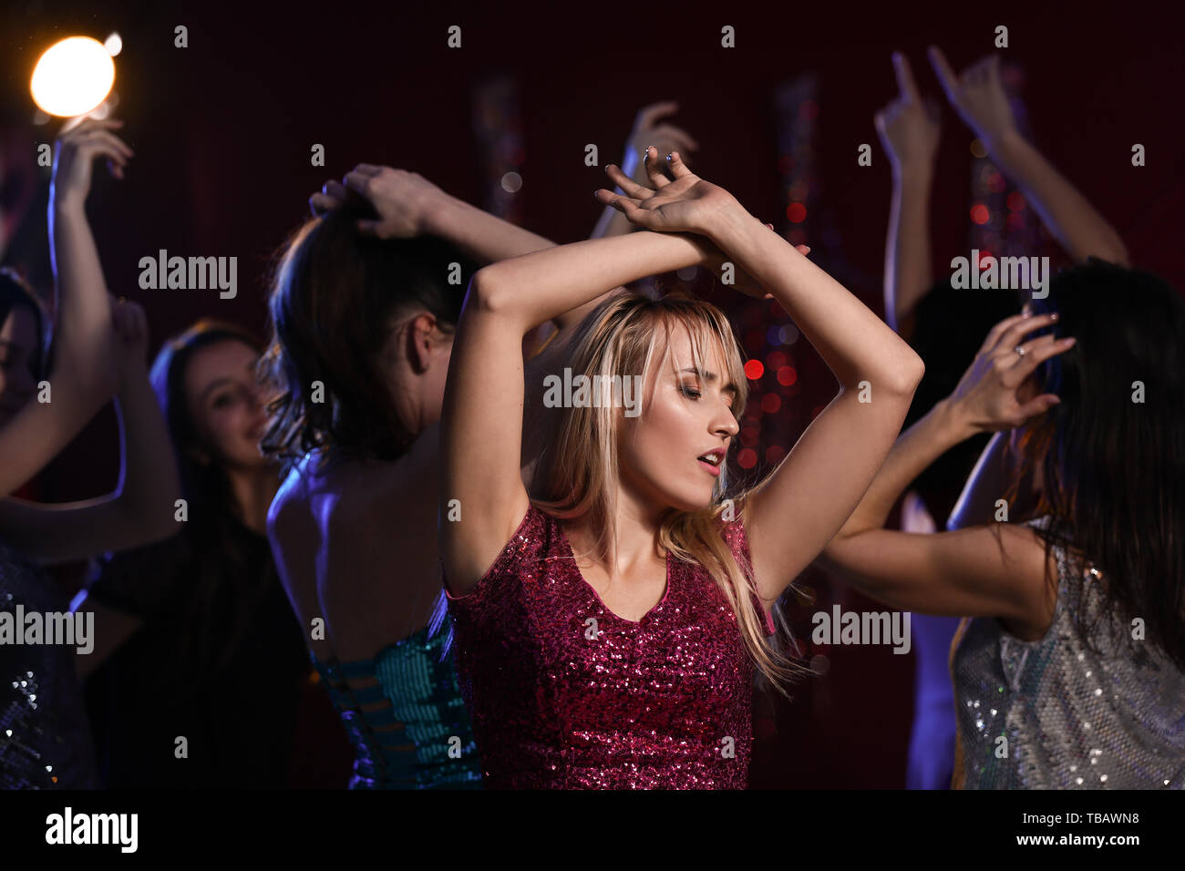Beautiful young woman dancing in night club Stock Photo - Alamy