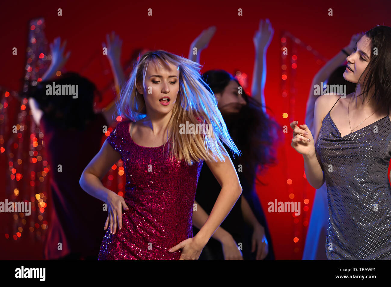 Beautiful young women dancing in night club Stock Photo - Alamy