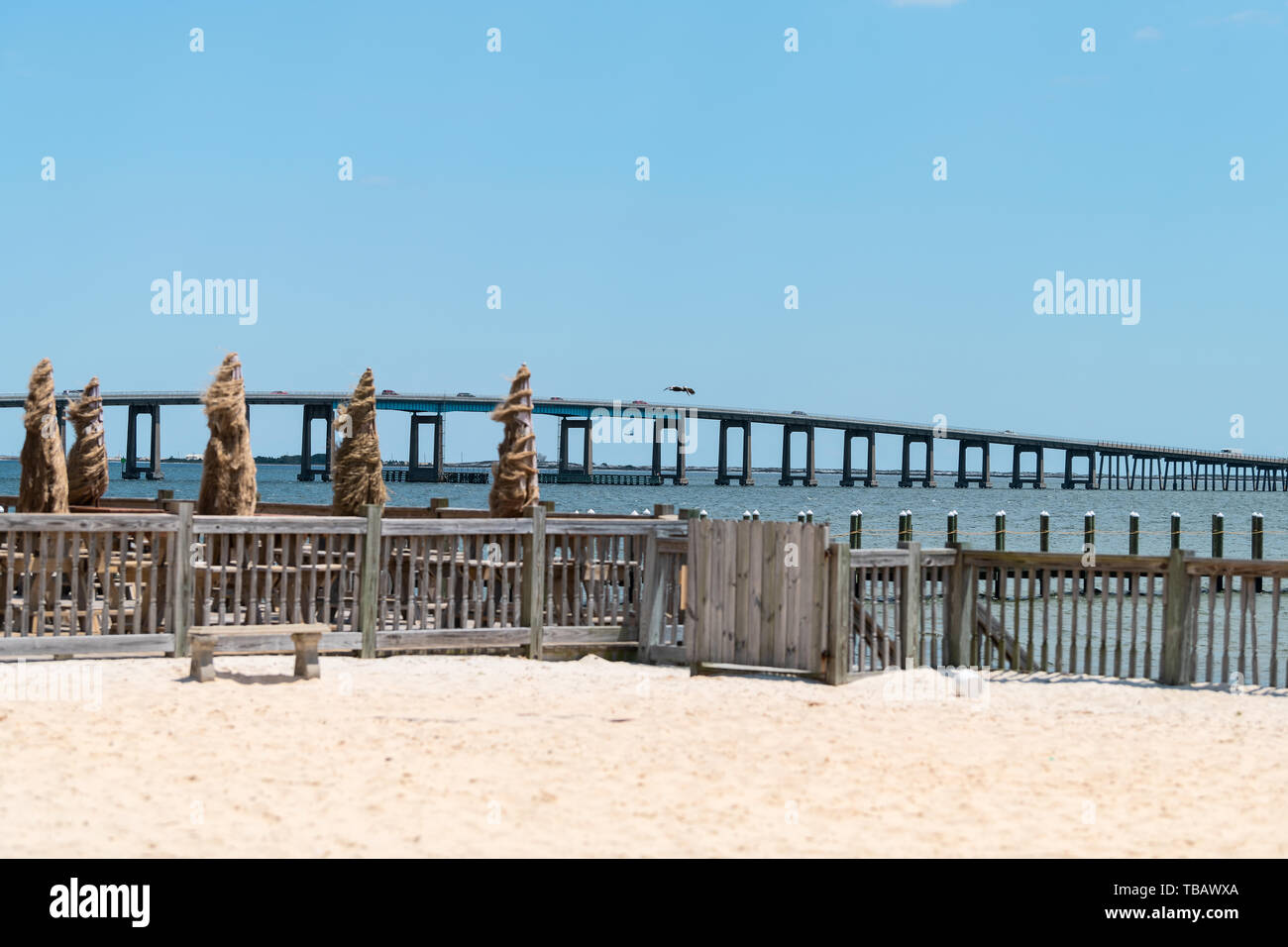 View from sand beach in Navarre on Pensacola Bay bridge with restaurant ...
