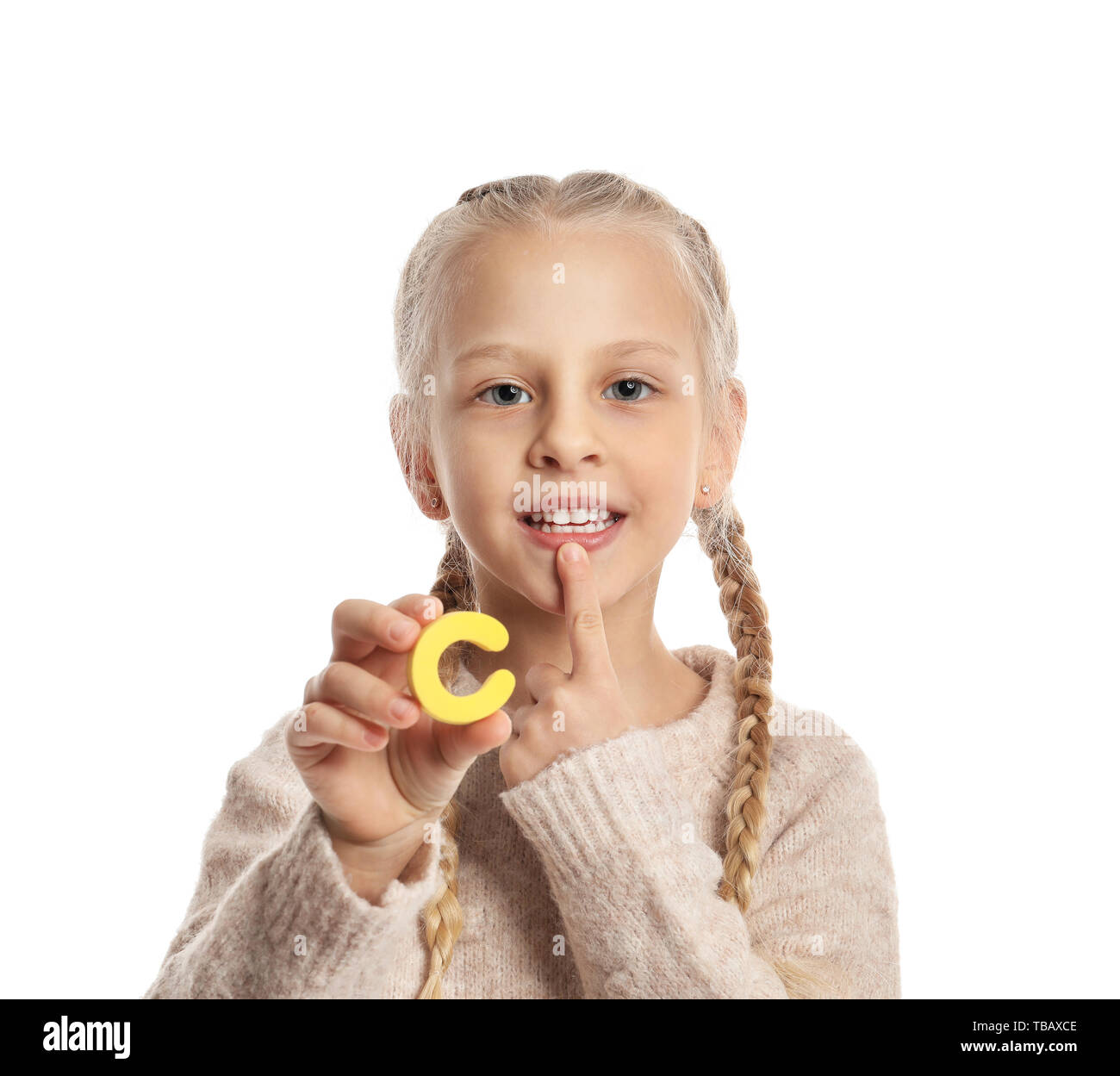Little girl training pronounce letters on white background Stock Photo ...