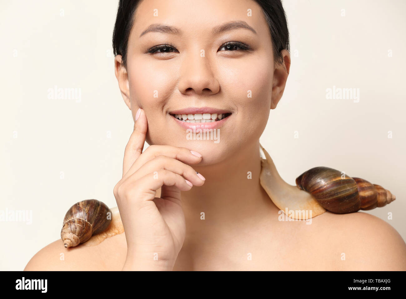 Asian woman with giant Achatina snails on white background Stock Photo ...