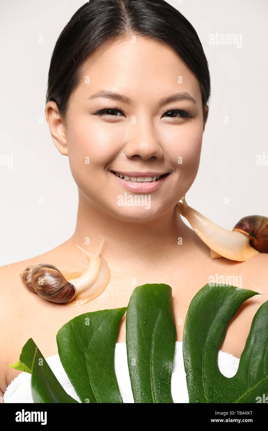 Asian woman with giant Achatina snails on white background Stock Photo ...