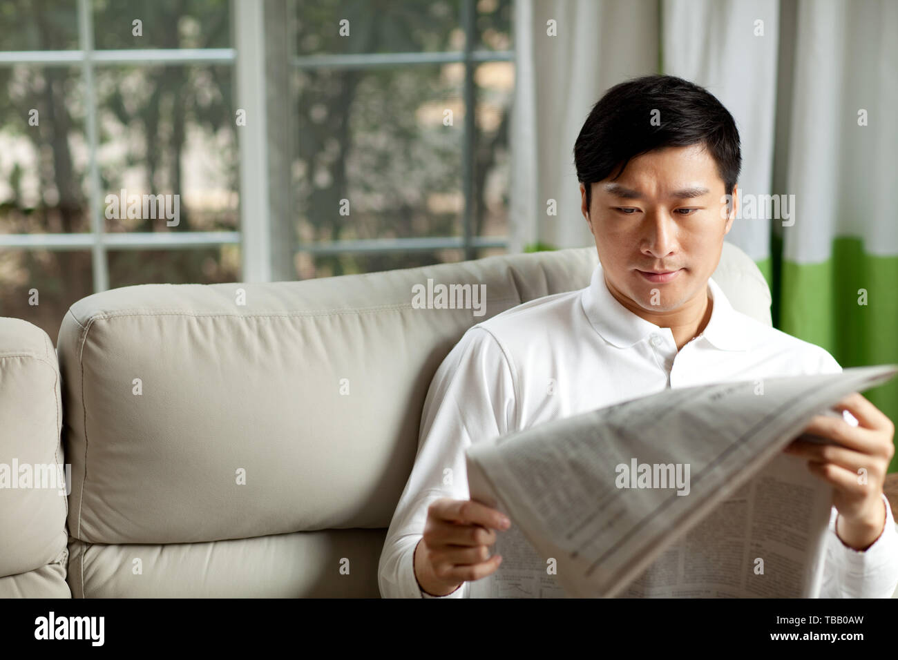 Sit on the couch and rest Stock Photo - Alamy