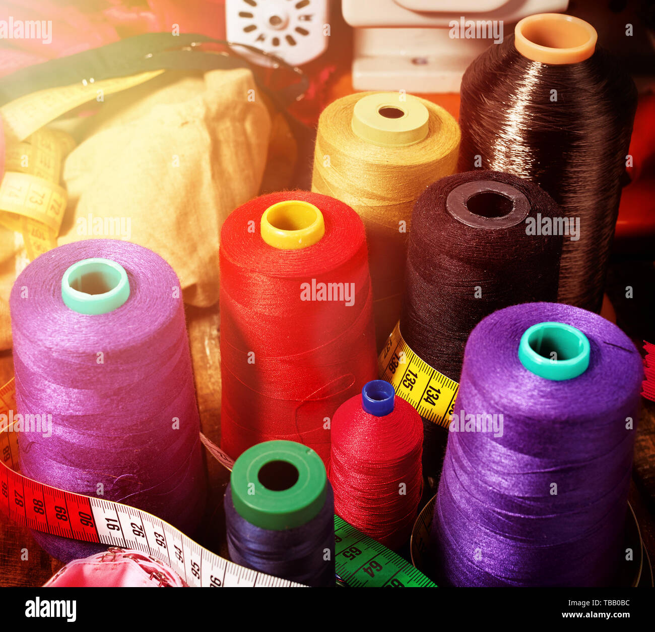 Coil overlock threads and measuring tape in light sun flare Stock Photo ...