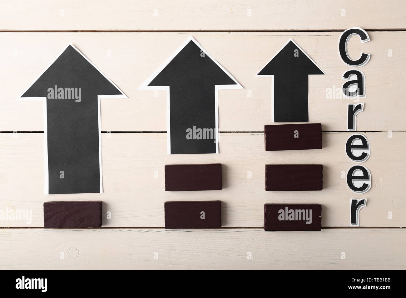 Blocks with pointing up arrows on white wooden background. Concept of ...