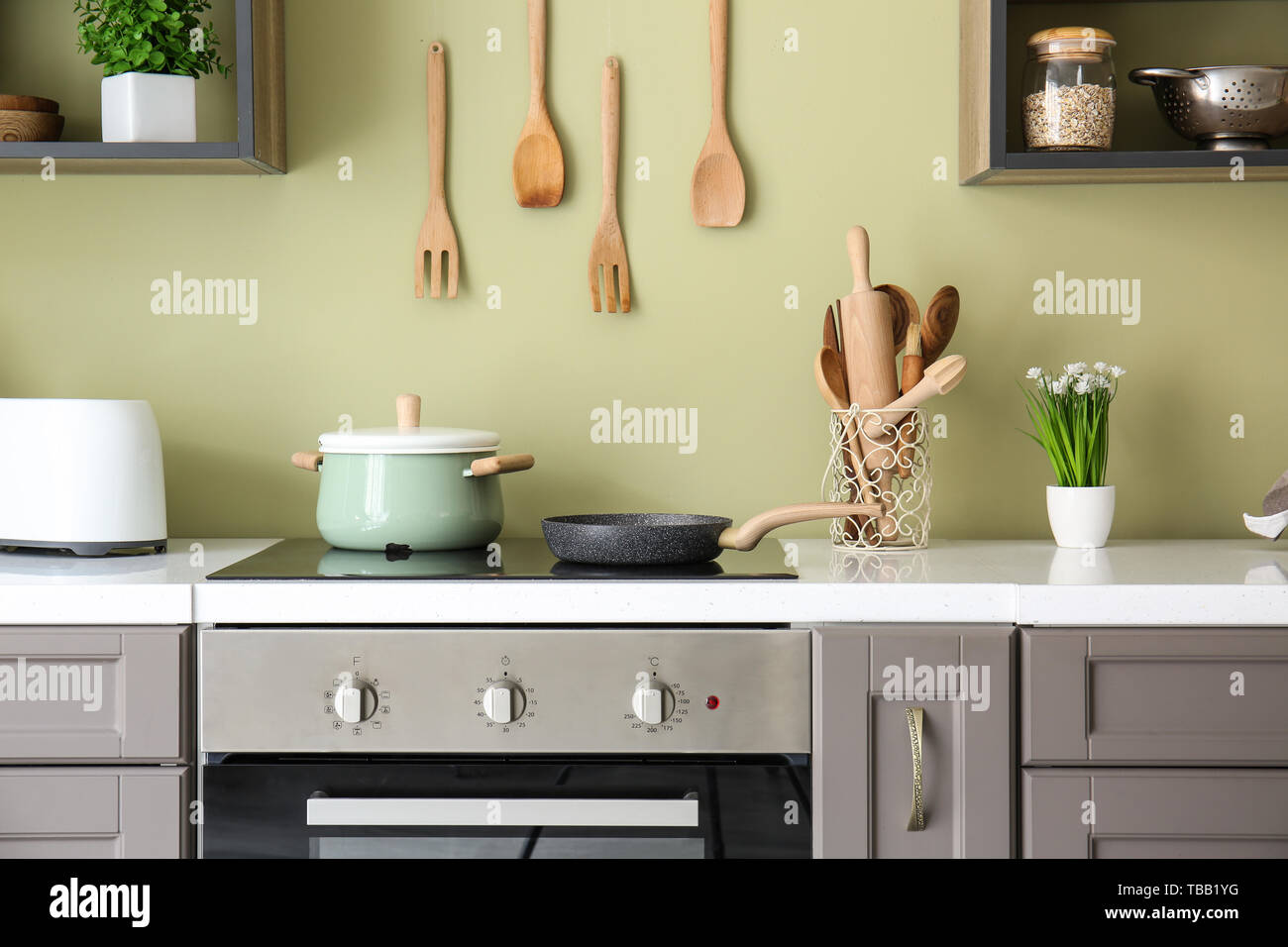 Modern electric stove with kitchenware Stock Photo - Alamy