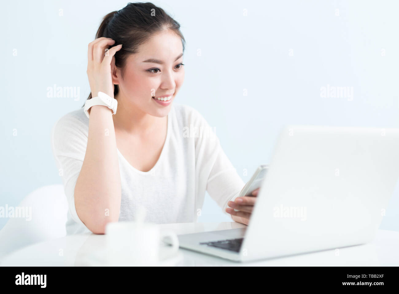 young pretty chinese woman working with laptop in office Stock Photo ...