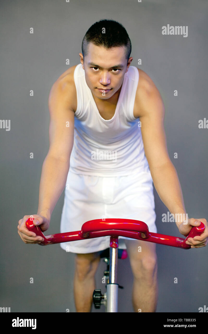 Riding a gym bike at the gym Stock Photo - Alamy