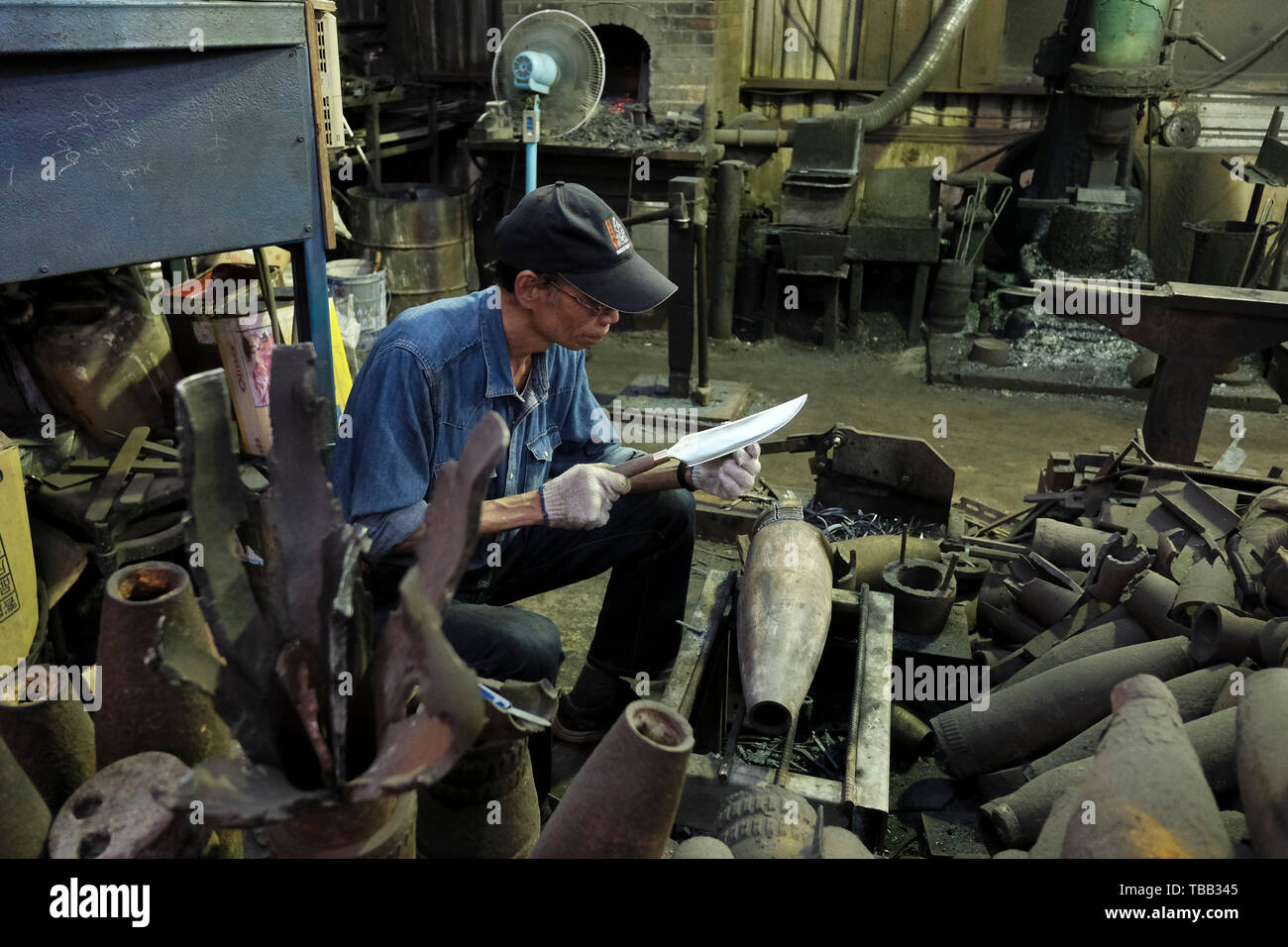 Taiwanese blacksmith Wu Tseng-tong known as Maestro Wu crafts a knife ...