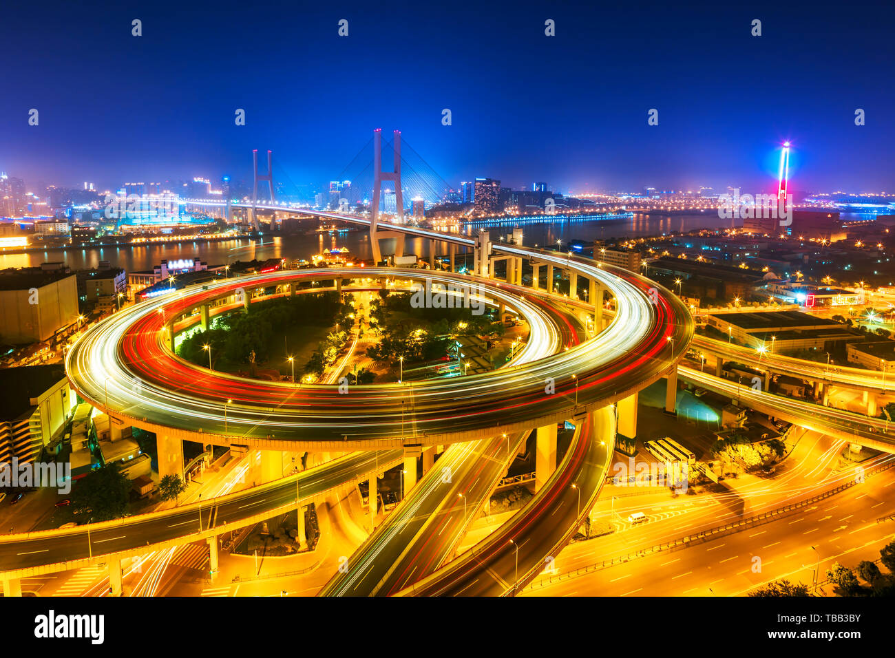 illuminated road intersection and traffic trails Stock Photo - Alamy