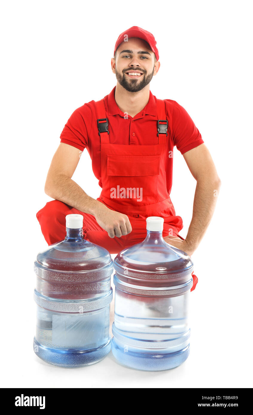 Delivery man with bottles of water on white background Stock Photo - Alamy