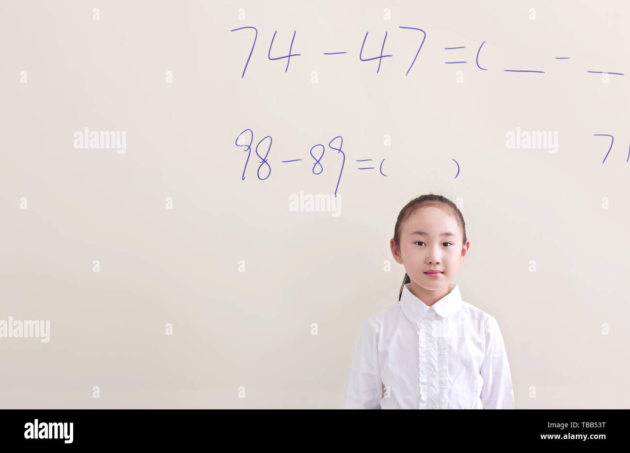 Three primary school students are in class in the classroom Stock Photo ...