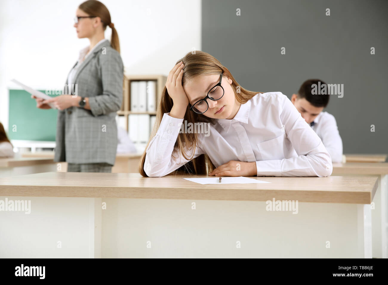 Girl passing school test in classroom Stock Photo - Alamy