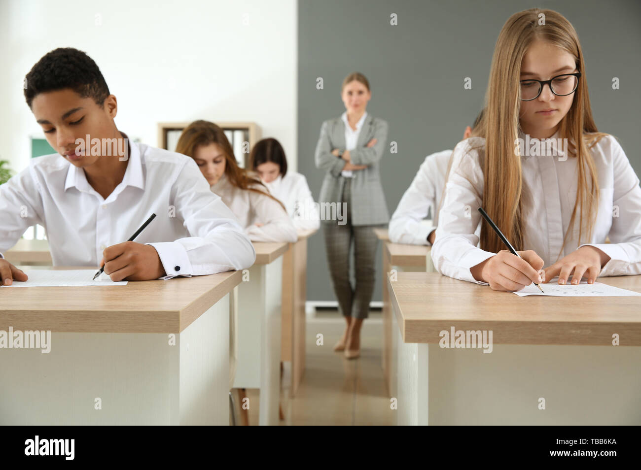 Pupils passing school test in classroom Stock Photo - Alamy