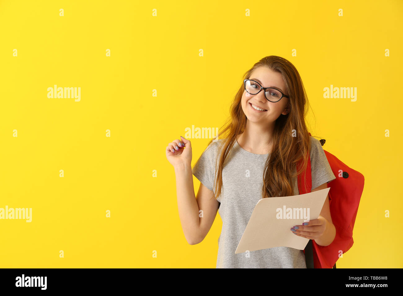 Happy girl with results of school test on color background Stock Photo ...