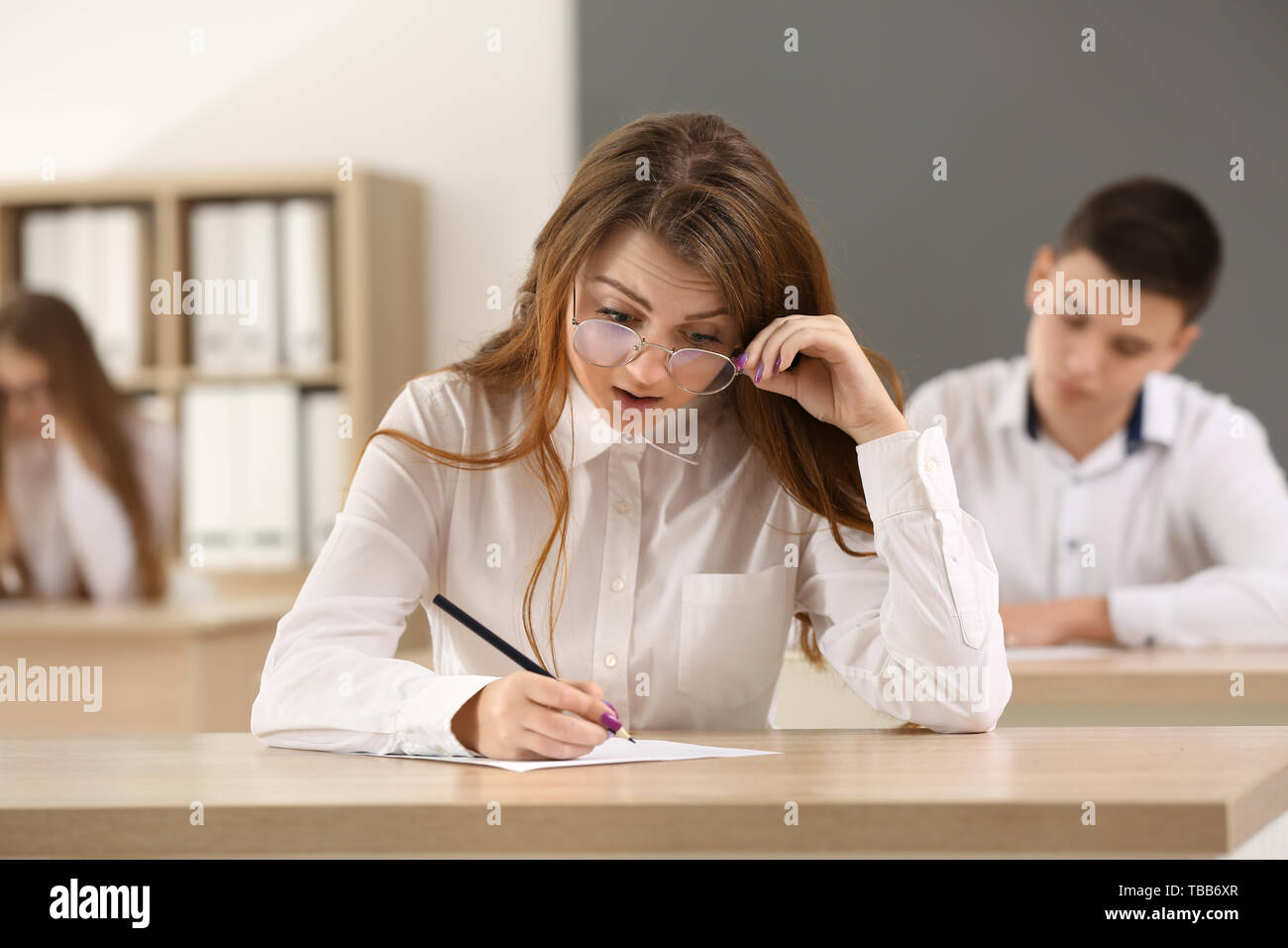Pupils passing school test in classroom Stock Photo - Alamy